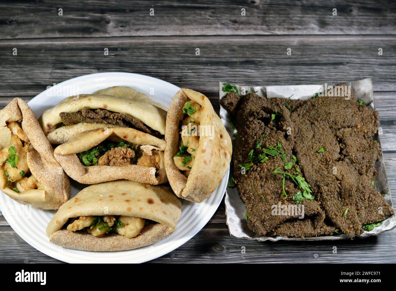 A plate of fried beef liver slices and fried shrimps, beef brain, beef ...