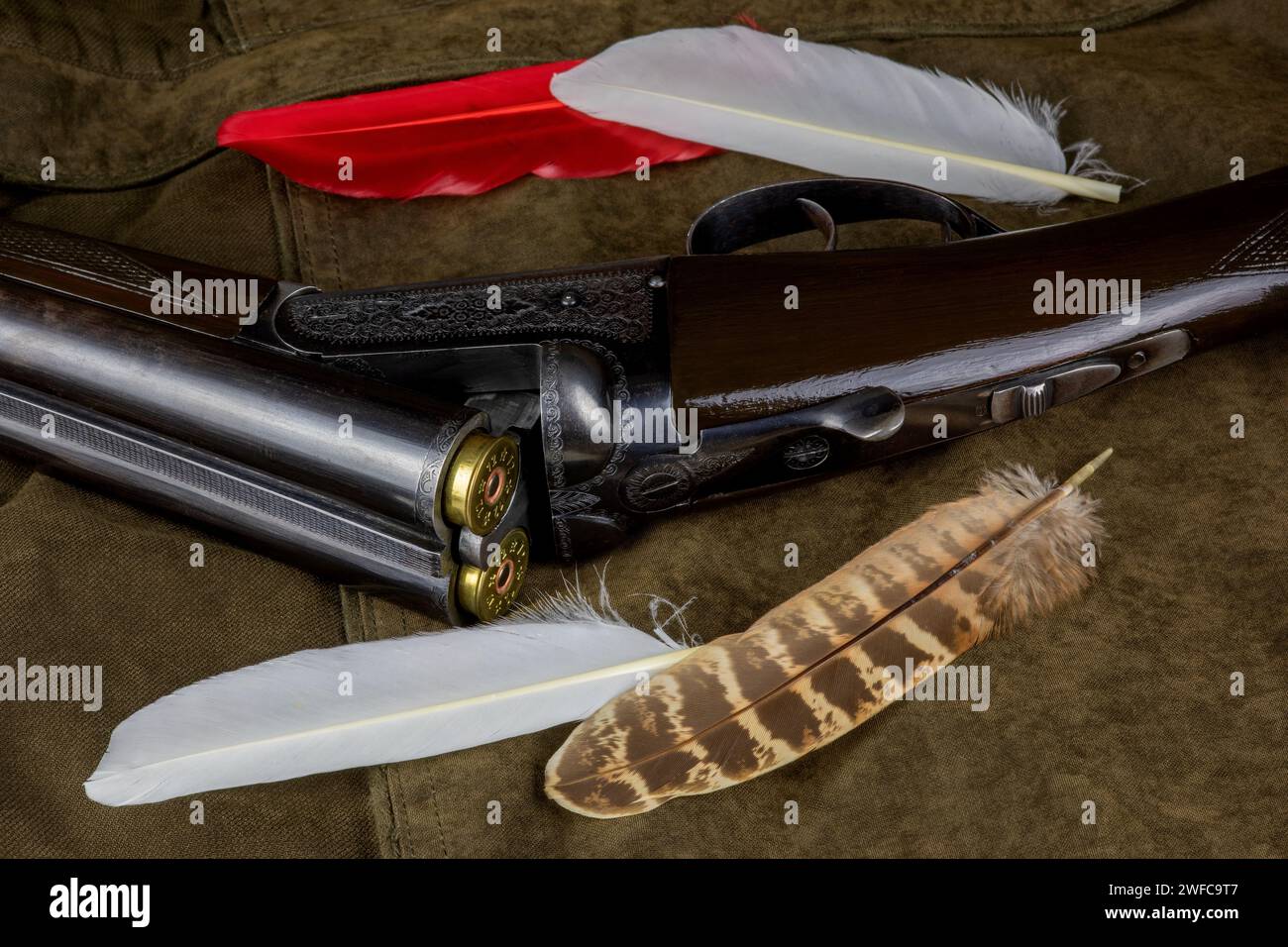 Vintage side by side shotgun on an outdoor field coat with assorted ...