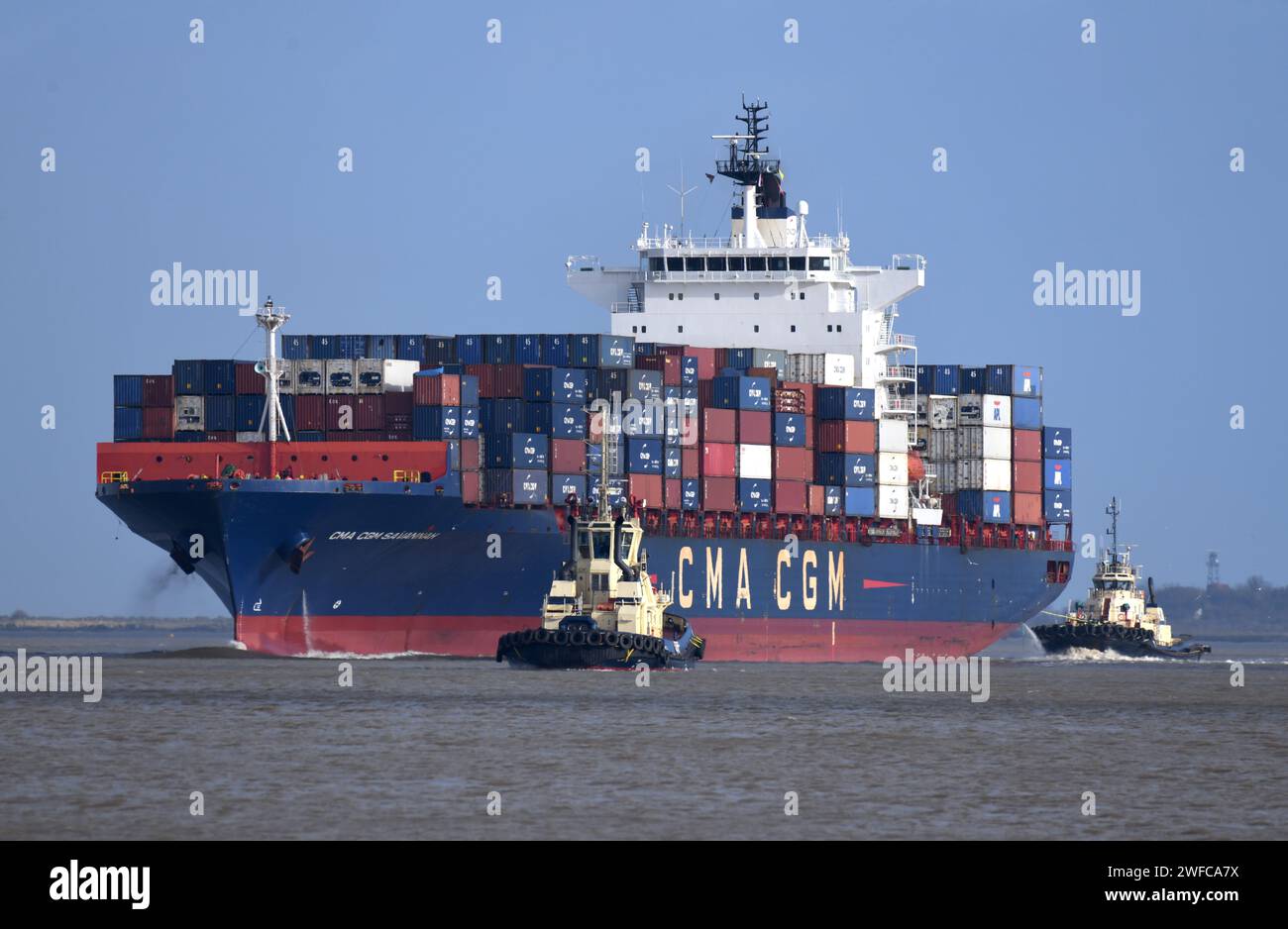 Buffeted by 20mph winds Svitzer tugs bring container ship CMA CGM ...