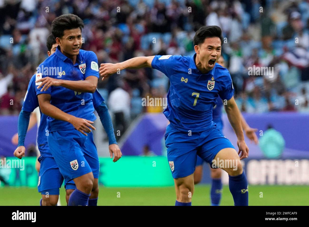 Thailand's Supachok Sarachat, right, celebrates after scoring his side ...