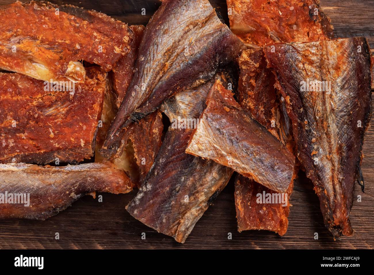 Pieces of cleaned dried fishbackground. Dry Peppered Pollack. Amber ...