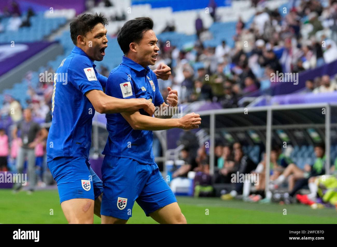 Thailand's Supachok Sarachat, right, celebrates after scoring his side ...