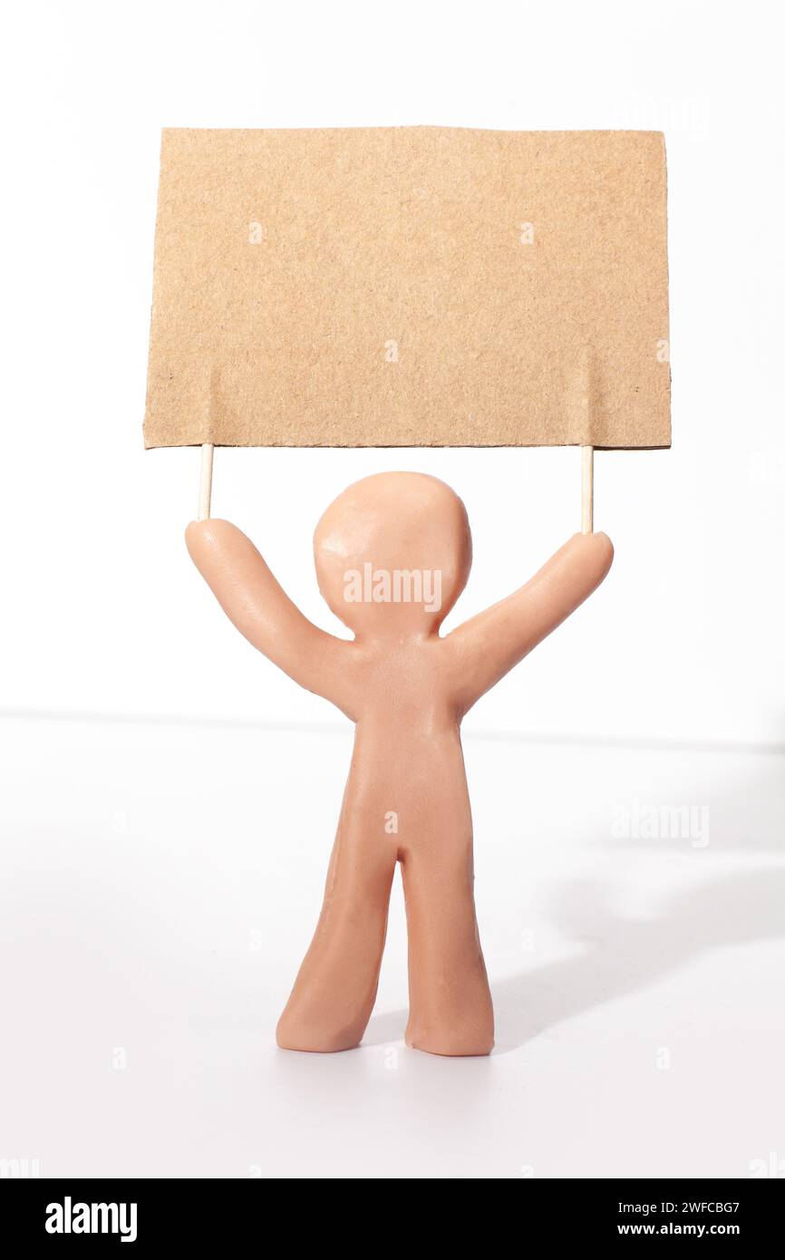 clay figure holding empty blank protest banner Stock Photo - Alamy