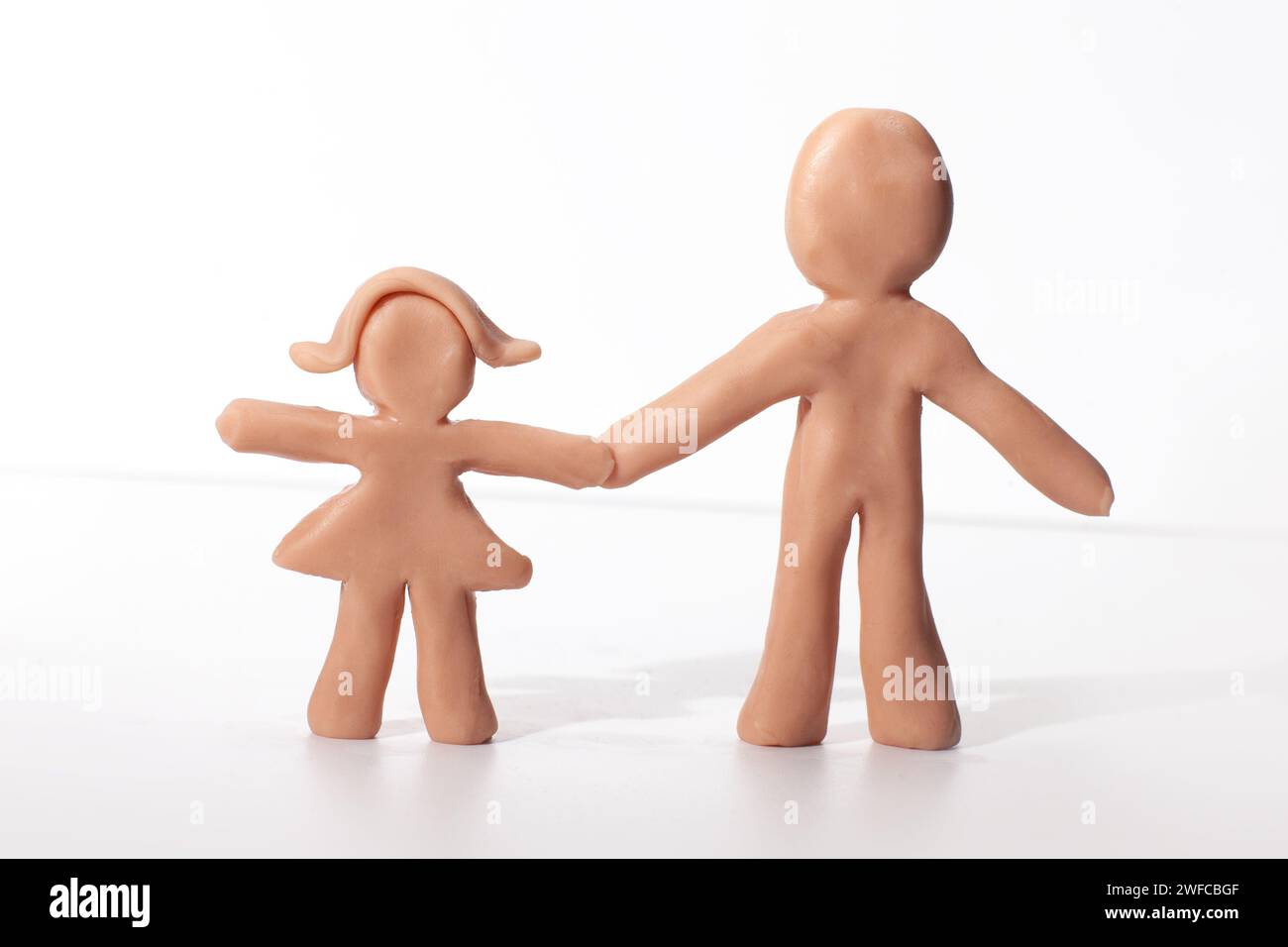 father and daughter clay figures holding hands isolated on white ...
