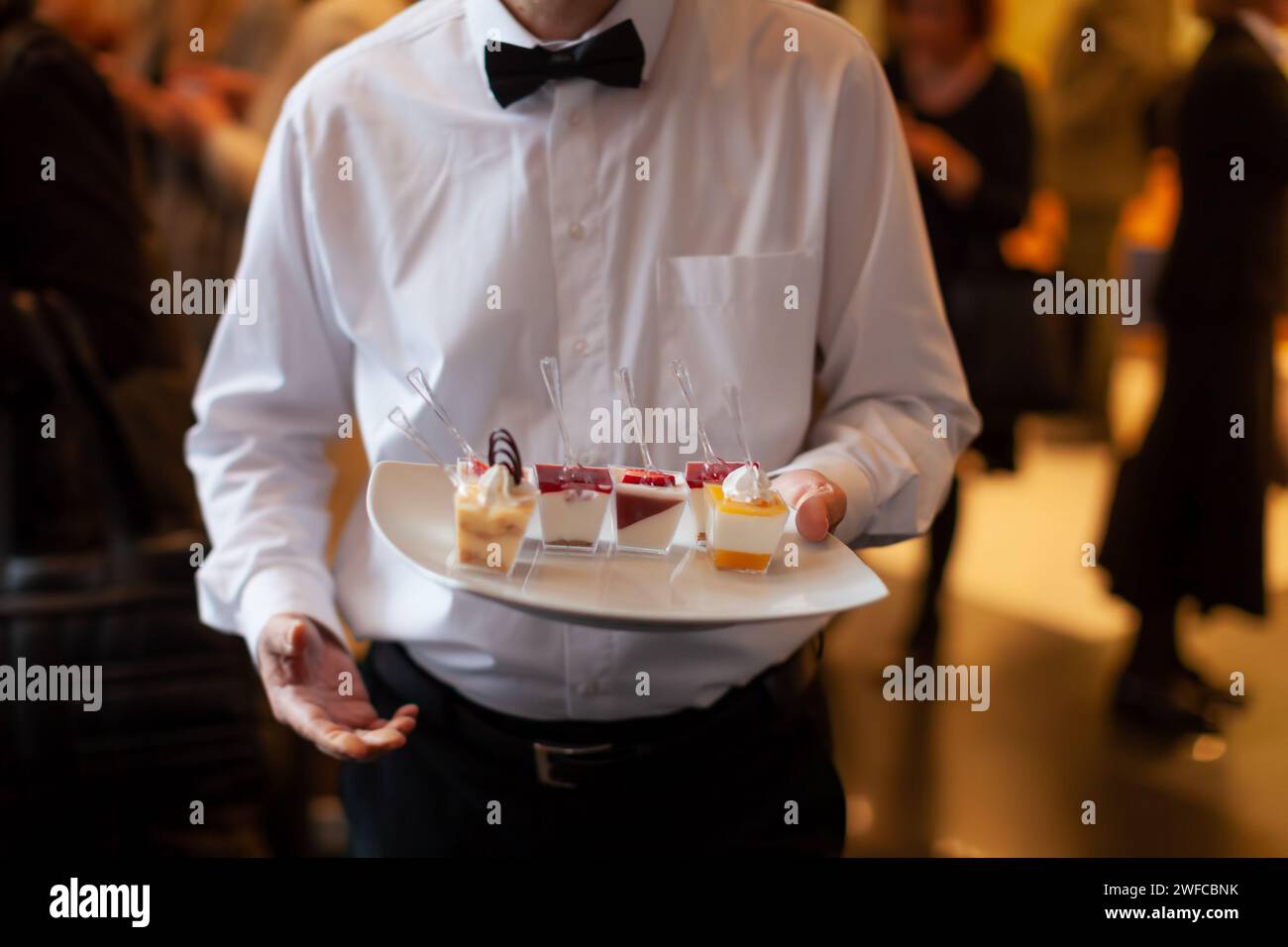waiter serving food during reception Stock Photo - Alamy