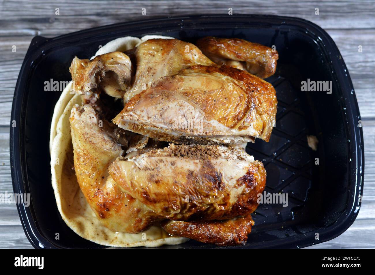 Arabic cuisine of machine grilled barbecued chicken, a whole chicken ...