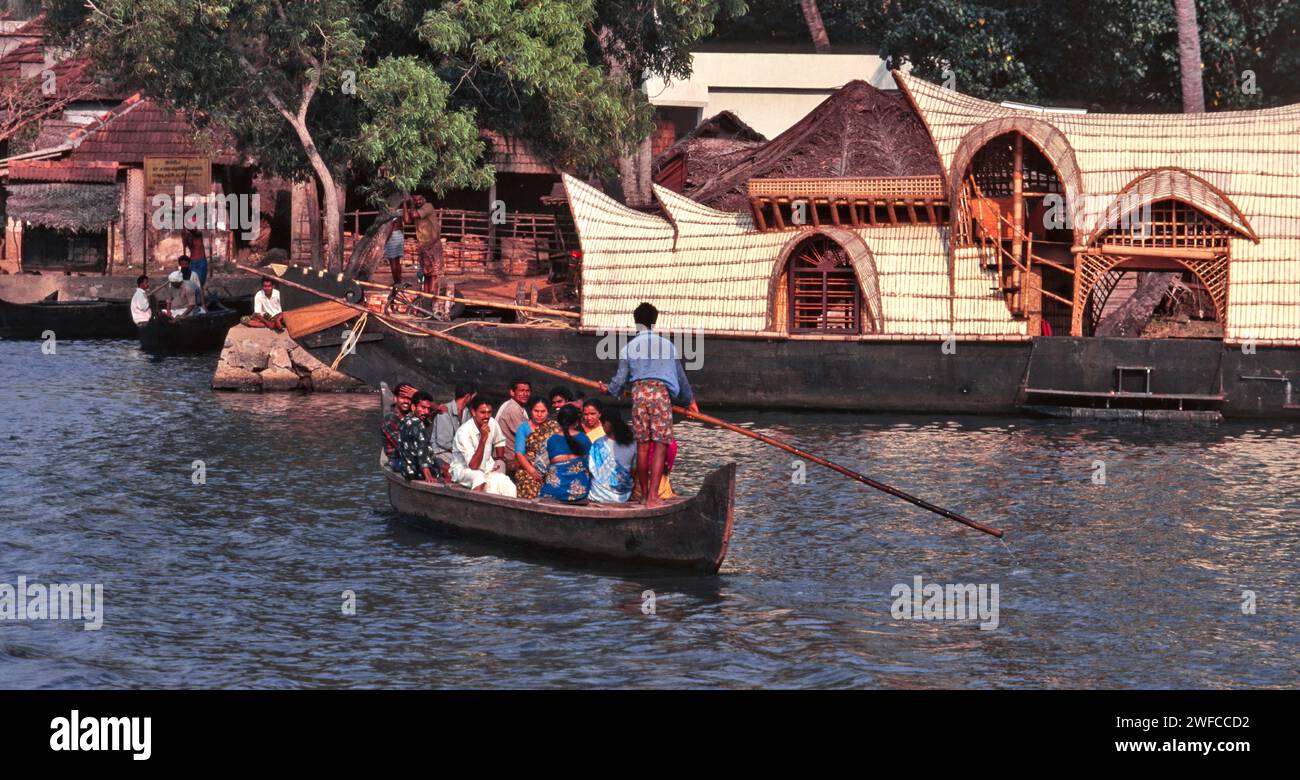 Rural India people in a traditional boat and a large moored houseboat ...