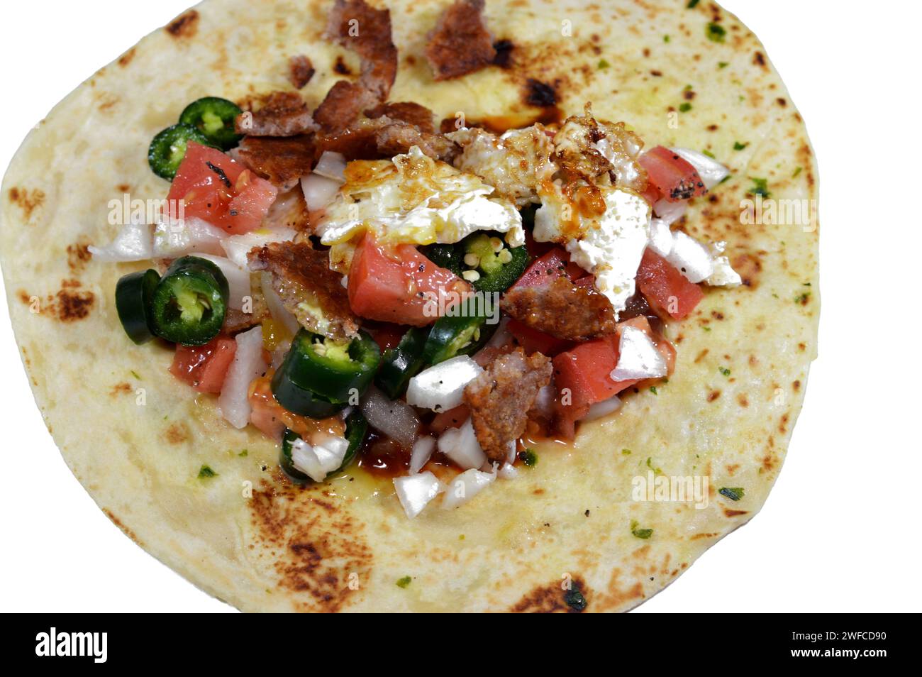 Pieces of beef burger, green pepper, onion, fried egg and ketchup on ...