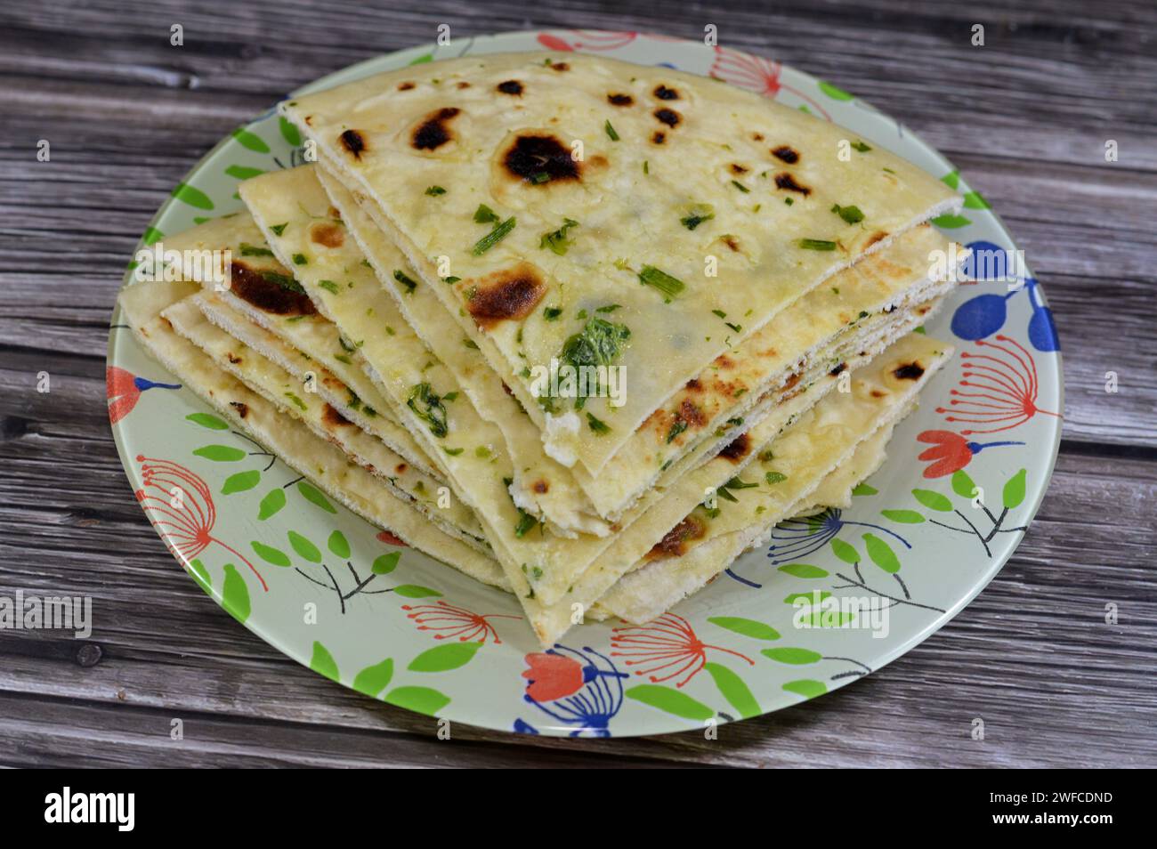 Indian naan bread baked inside a very hot clay tandoor oven, delicious ...