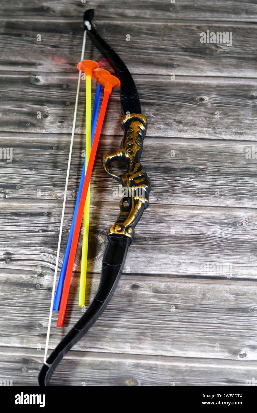 A plastic toy of a bow and arrows, Archery, The bow and arrow is a ...