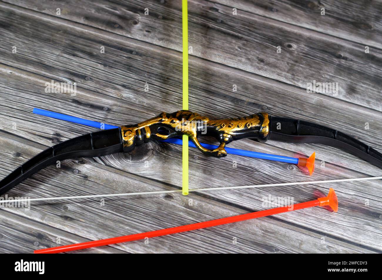 A plastic toy of a bow and arrows, Archery, The bow and arrow is a ...