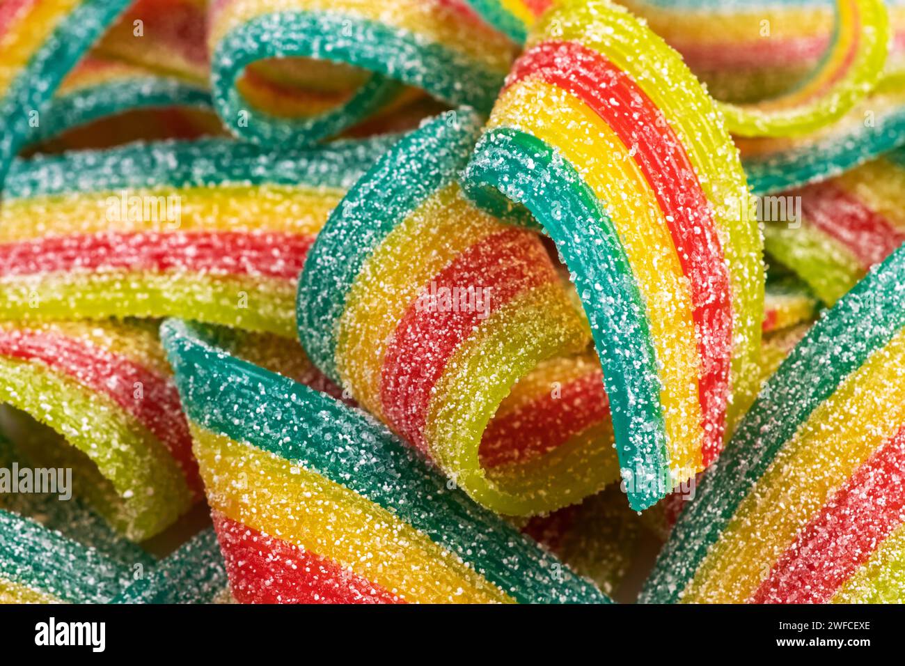 Rainbow sour jelly candies strips in sugar sprinkle Stock Photo - Alamy