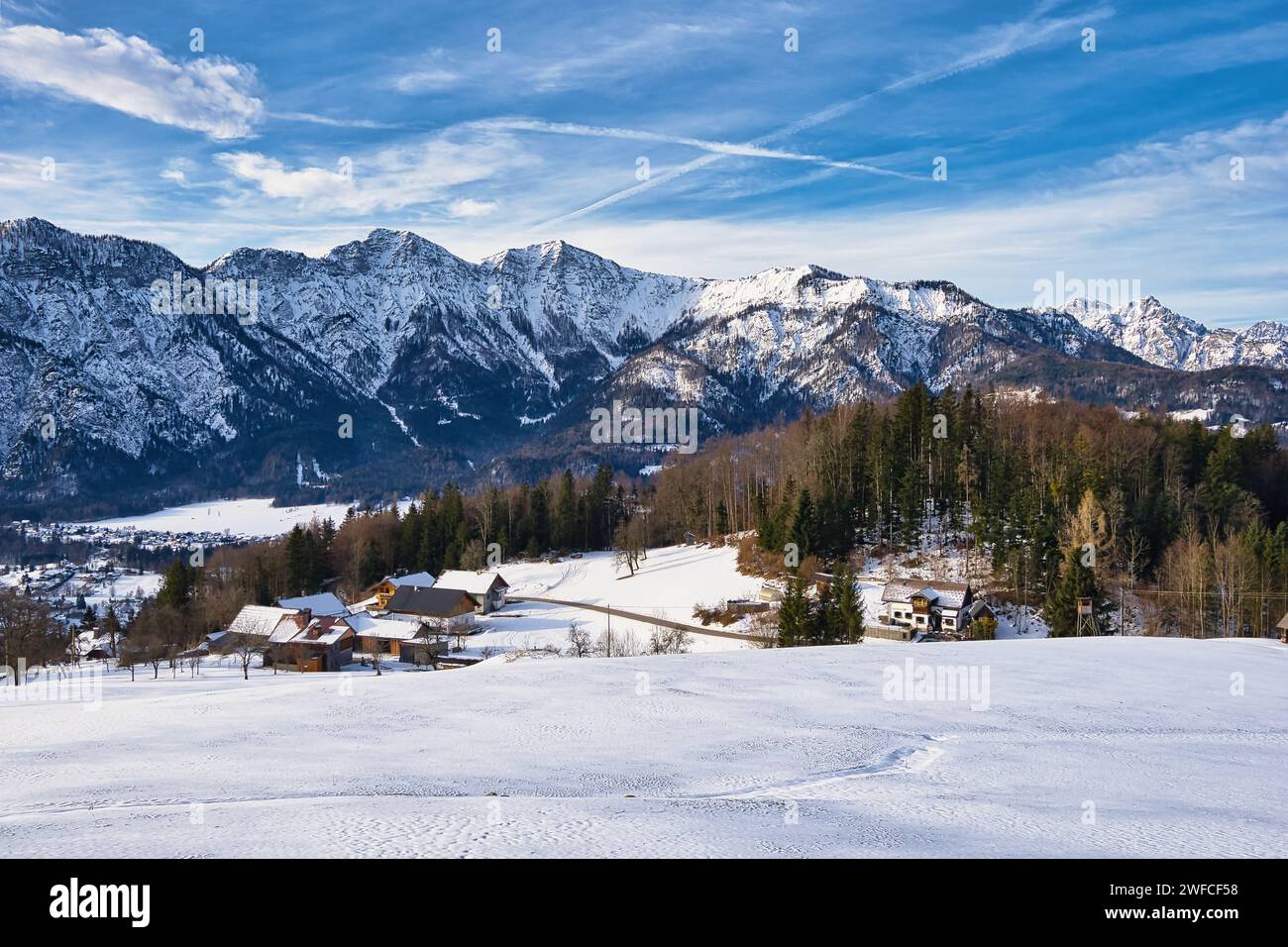 A Snow-covered hill with towering mountains in the World Heritage ...