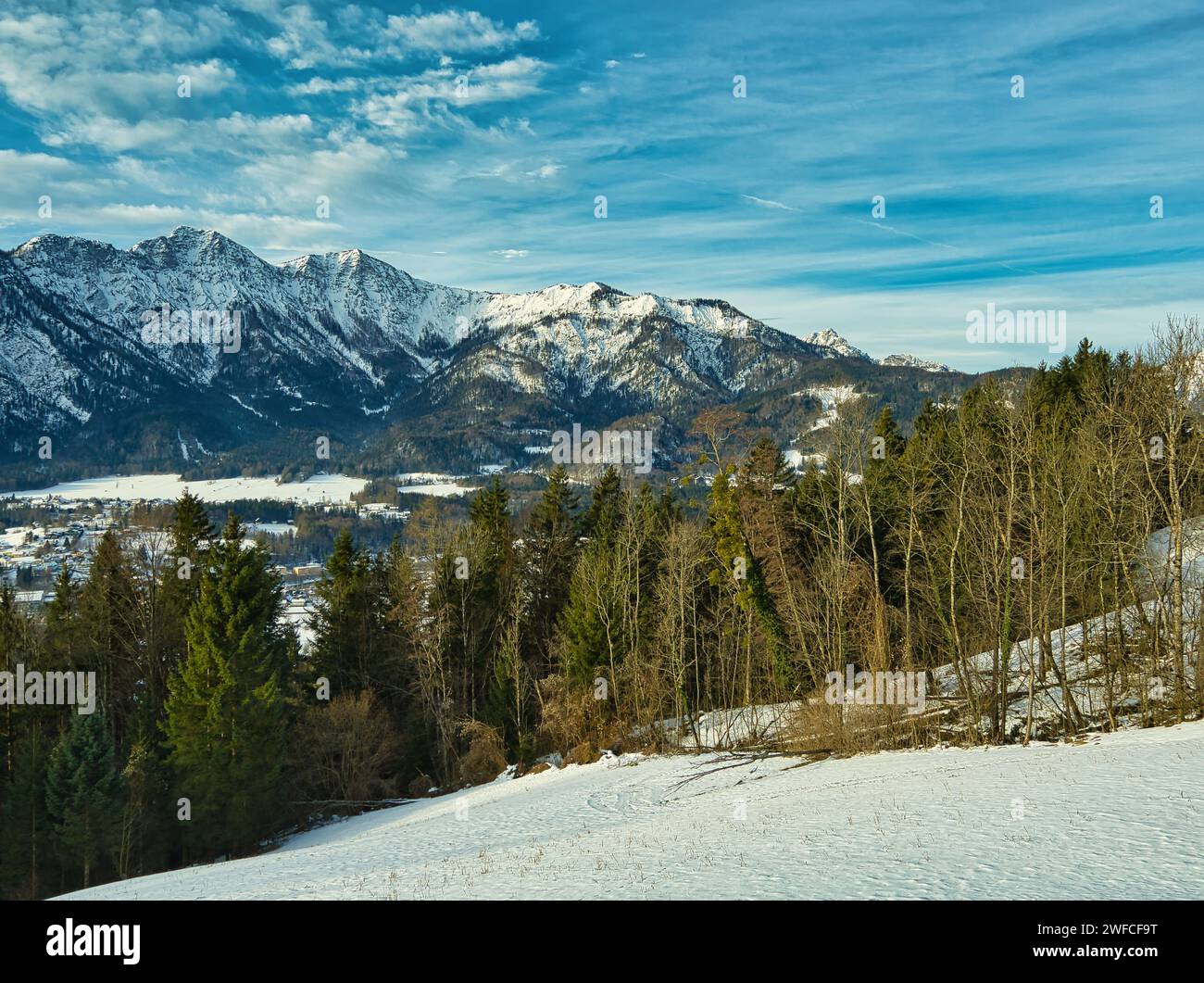 A Snow-covered ground with a towering hill in the World Heritage region ...