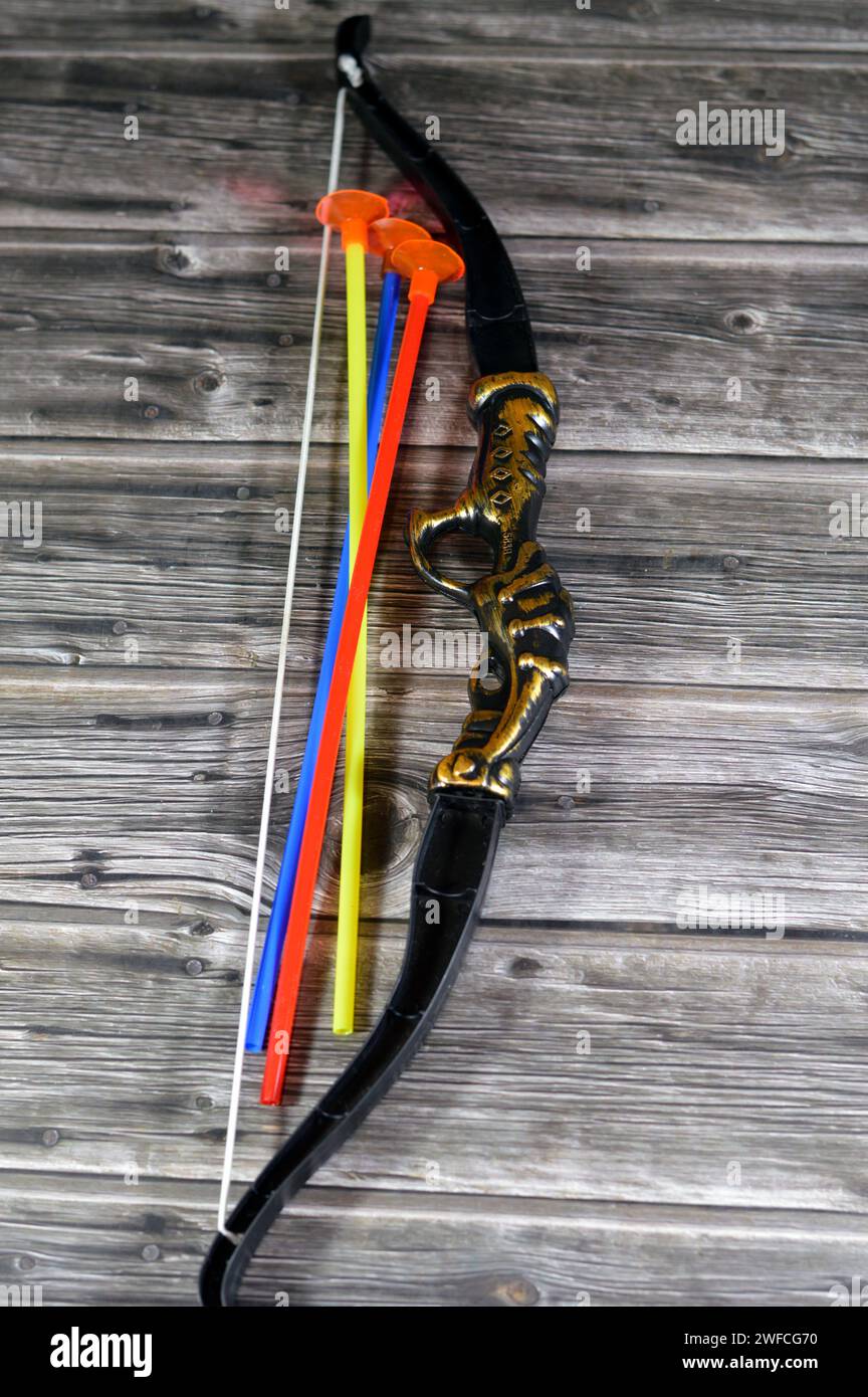 A plastic toy of a bow and arrows, Archery, The bow and arrow is a ...