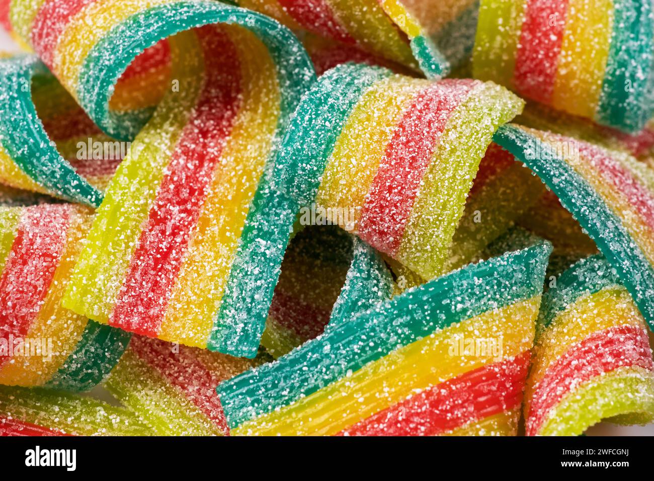 Rainbow sour jelly candies strips in sugar sprinkle Stock Photo - Alamy