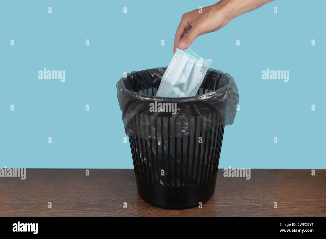 recycling, waste sorting and pandemic concept - hand throwing used ...