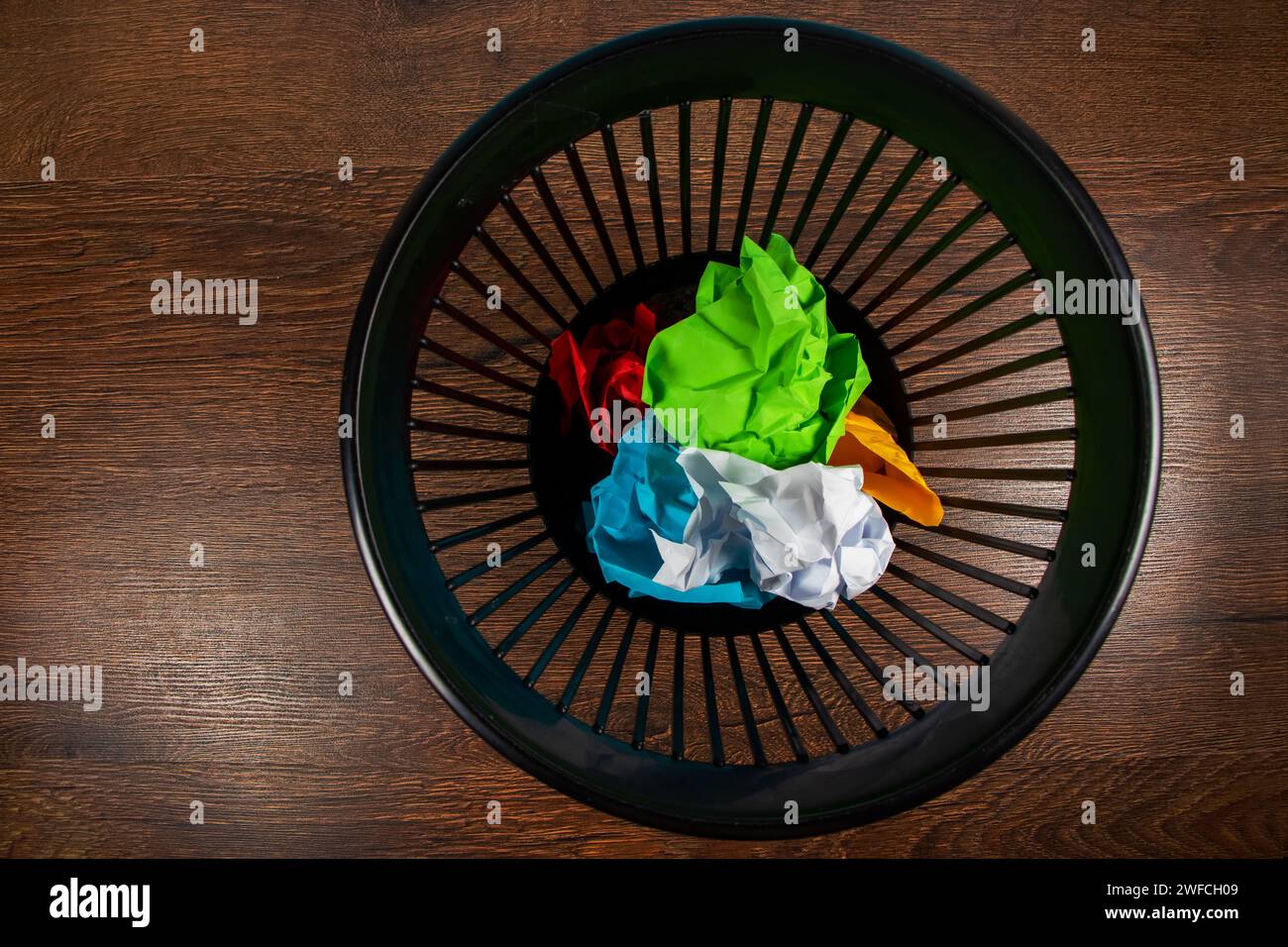 Recycling bin full of crumpled papers over white background Stock Photo ...