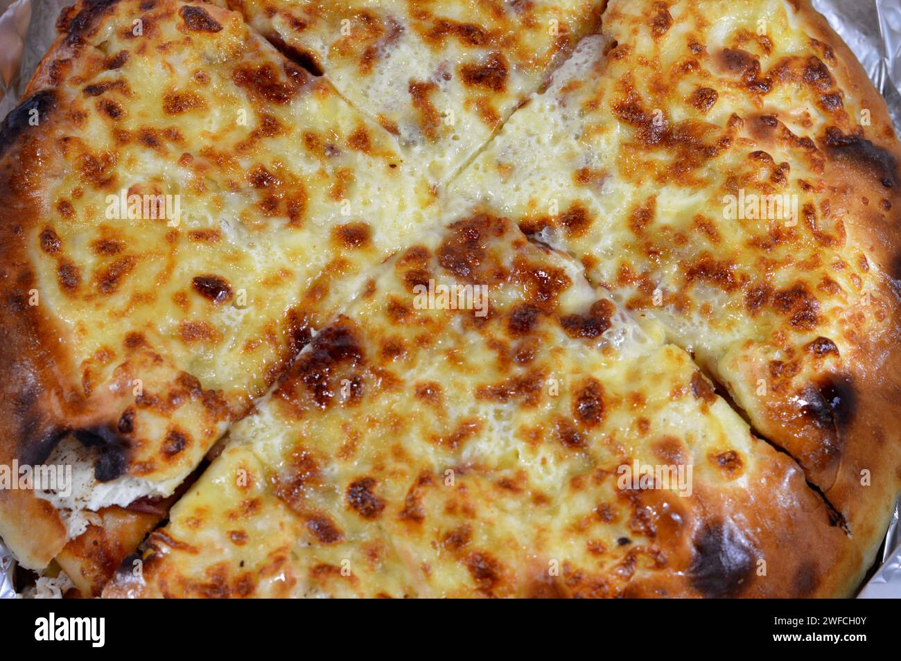 Multi-layers baked pizza cake, consists of layers of salami, barbeque ...