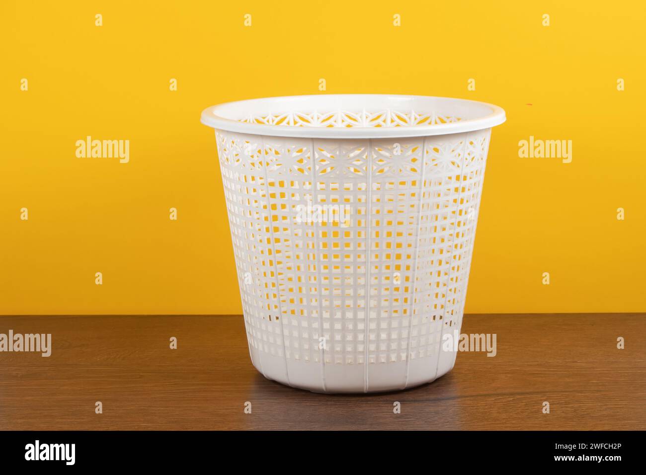 Empty trash, clean garbage bin, plastic basket bin on yellow background ...