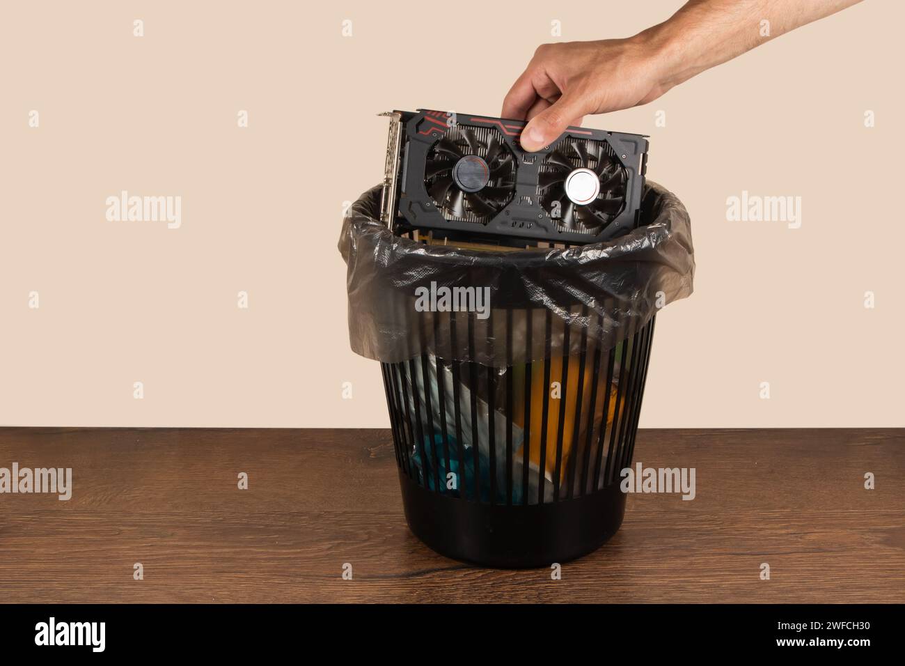 throwing a video card in the trash bin, a computer video card in hand ...