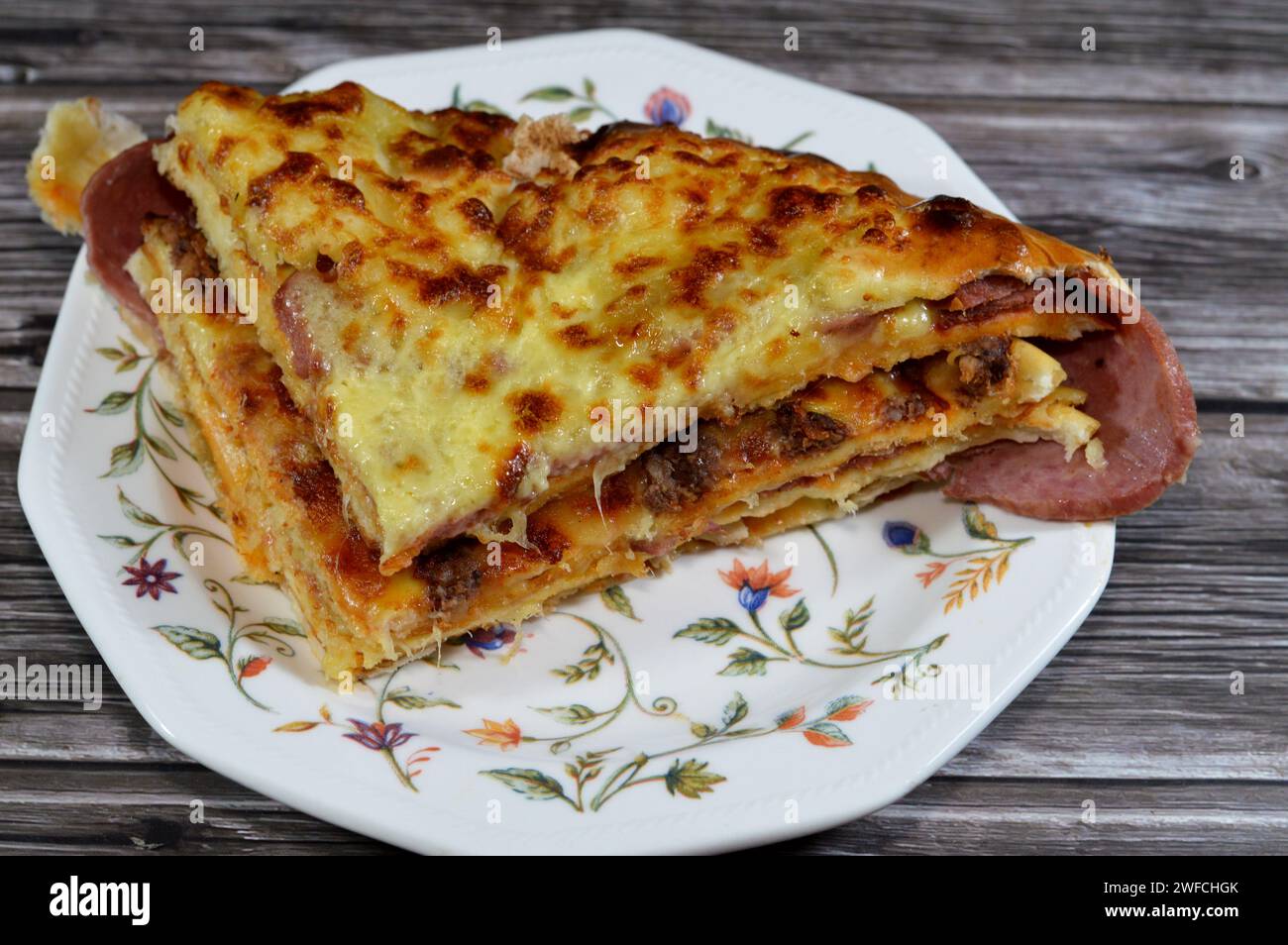 Multi-layers baked pizza cake, consists of layers of salami, barbeque ...