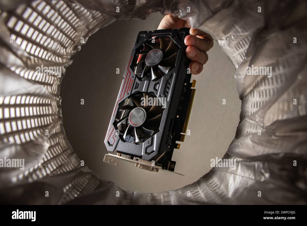 throwing a video card in the trash bin, a computer video card in hand ...