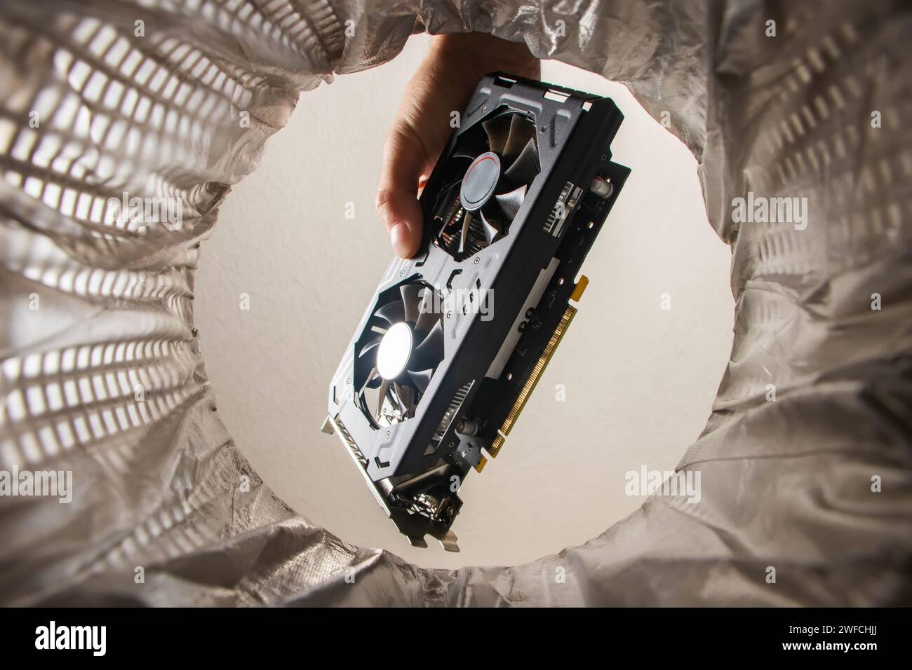 throwing a video card in the trash bin, a computer video card in hand ...