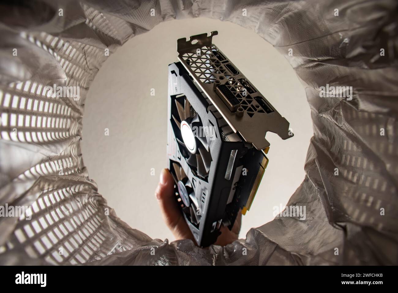 throwing a video card in the trash bin, a computer video card in hand ...