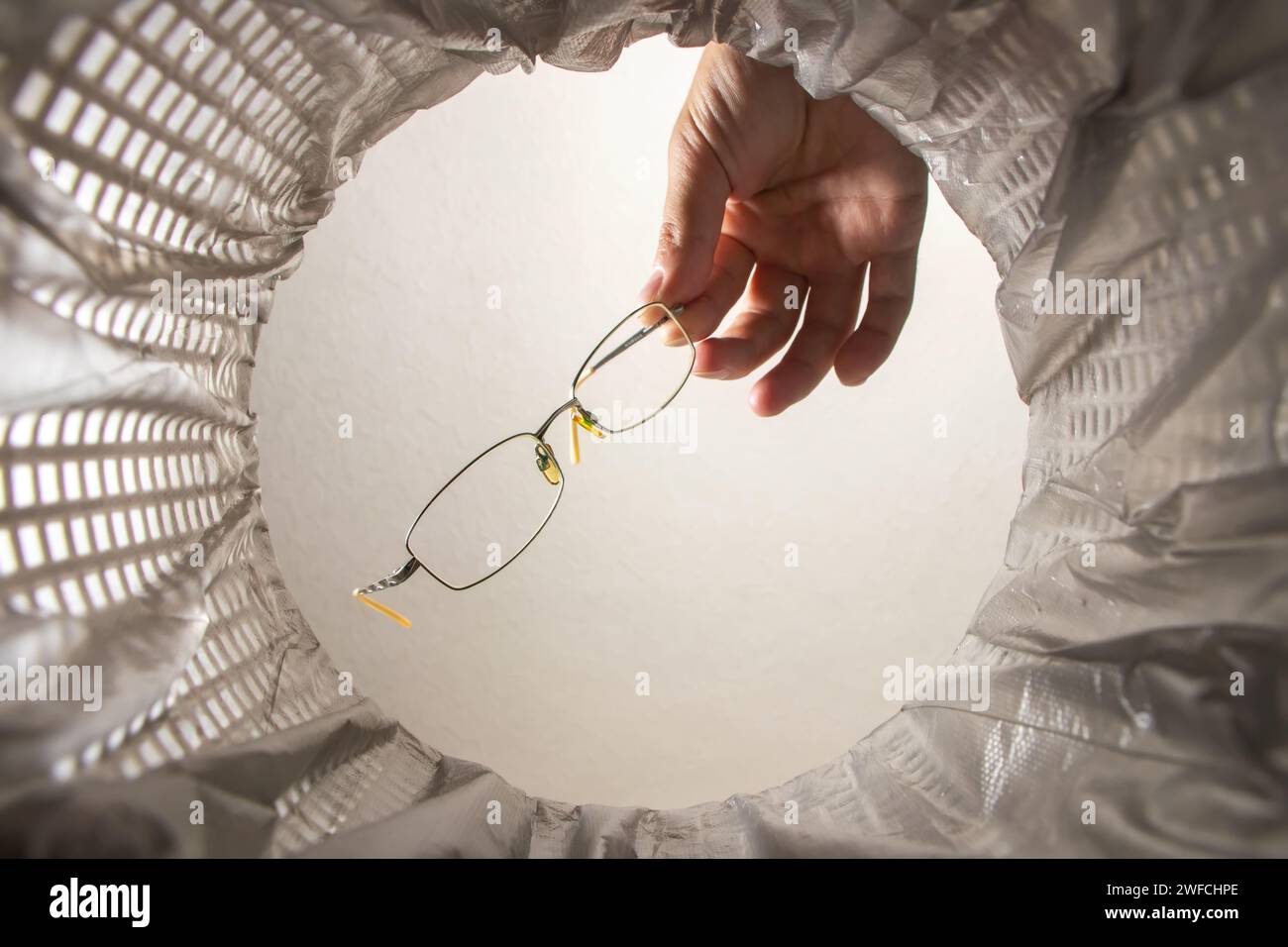 throwing glass in the trash inside view. Vision correction Stock Photo ...