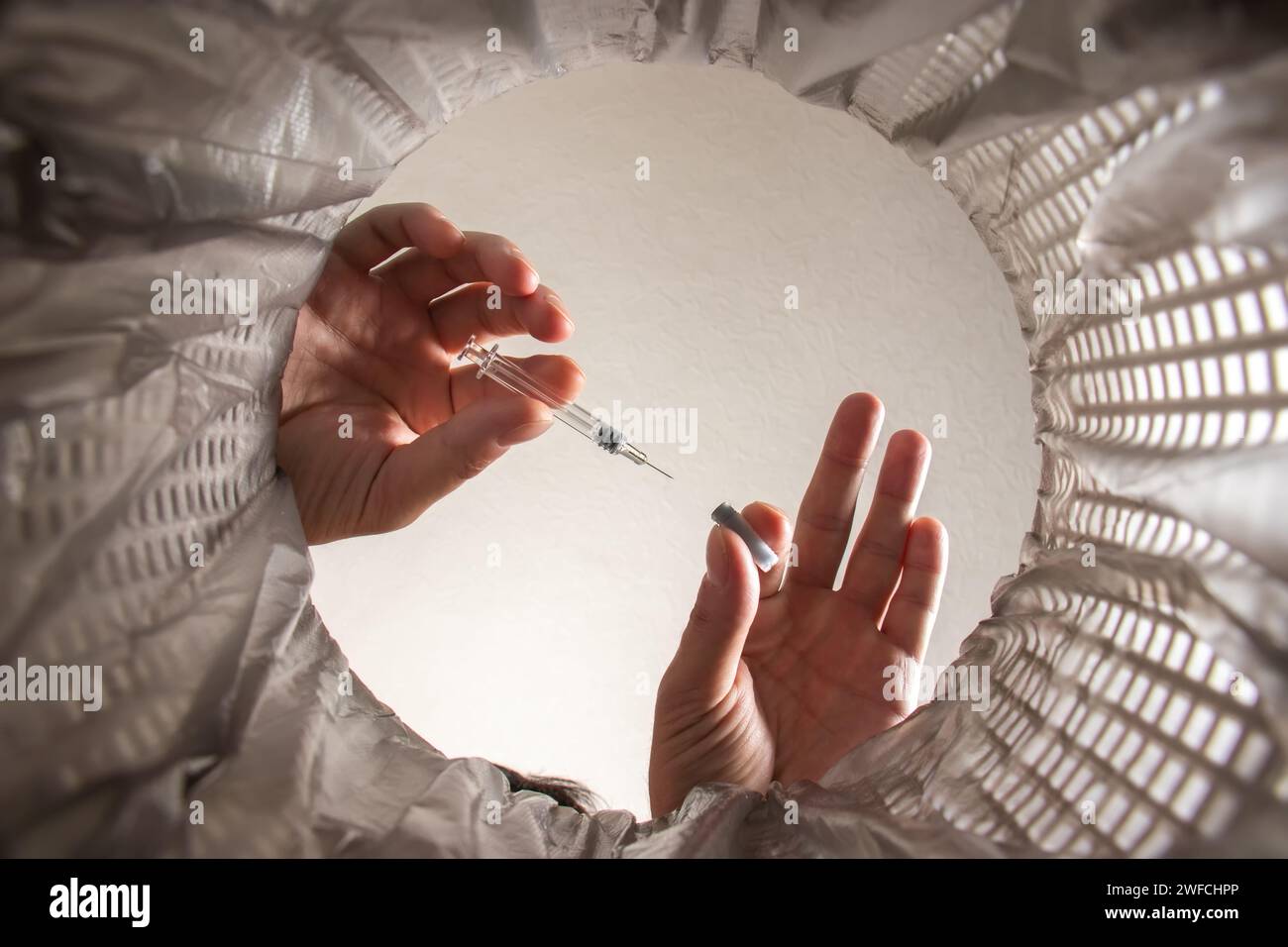 Hand throws syringe into trash bin with package. Inside view Stock ...