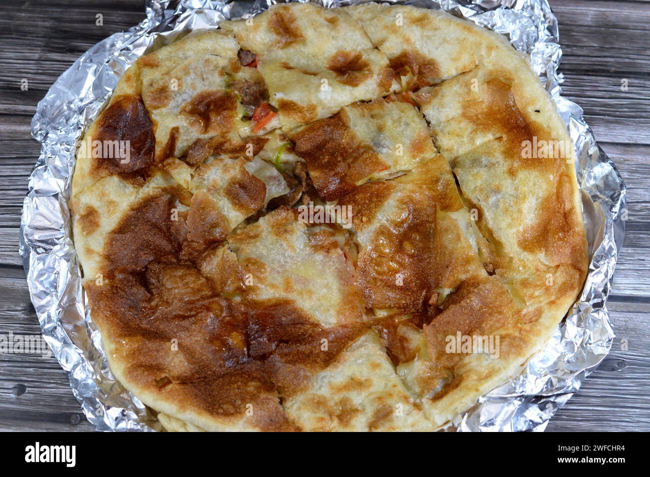 Middle Eastern meat sausage pie baked in the oven and sliced into ...