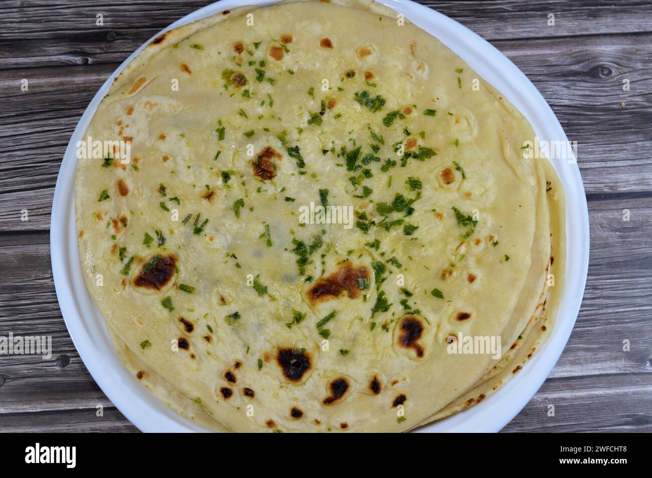 Indian naan bread baked inside a very hot clay tandoor oven, delicious ...