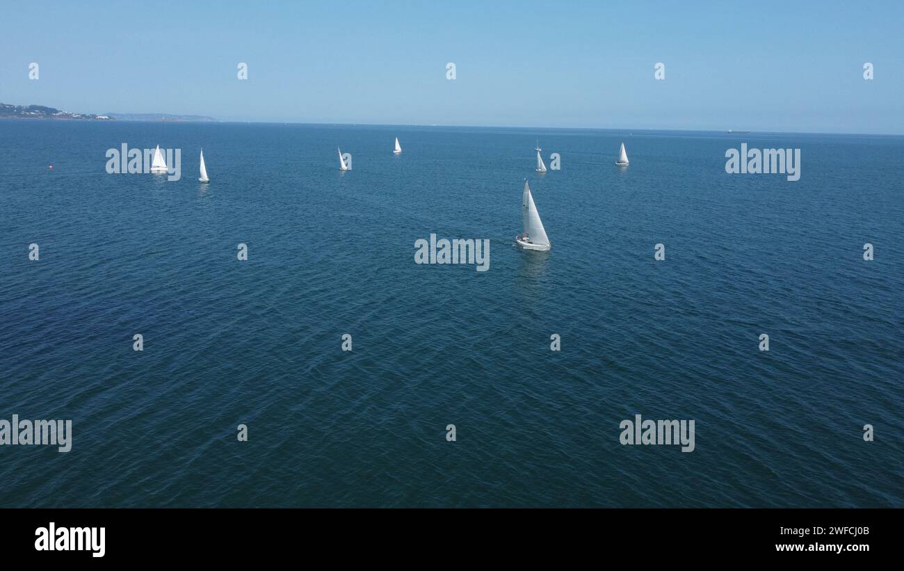 Sailboats in the calm waters on a calm blue ocean with clear skies in ...