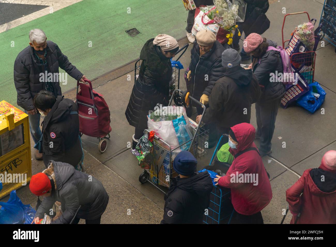 Clients with their shopping carts and shopping bags filled with ...