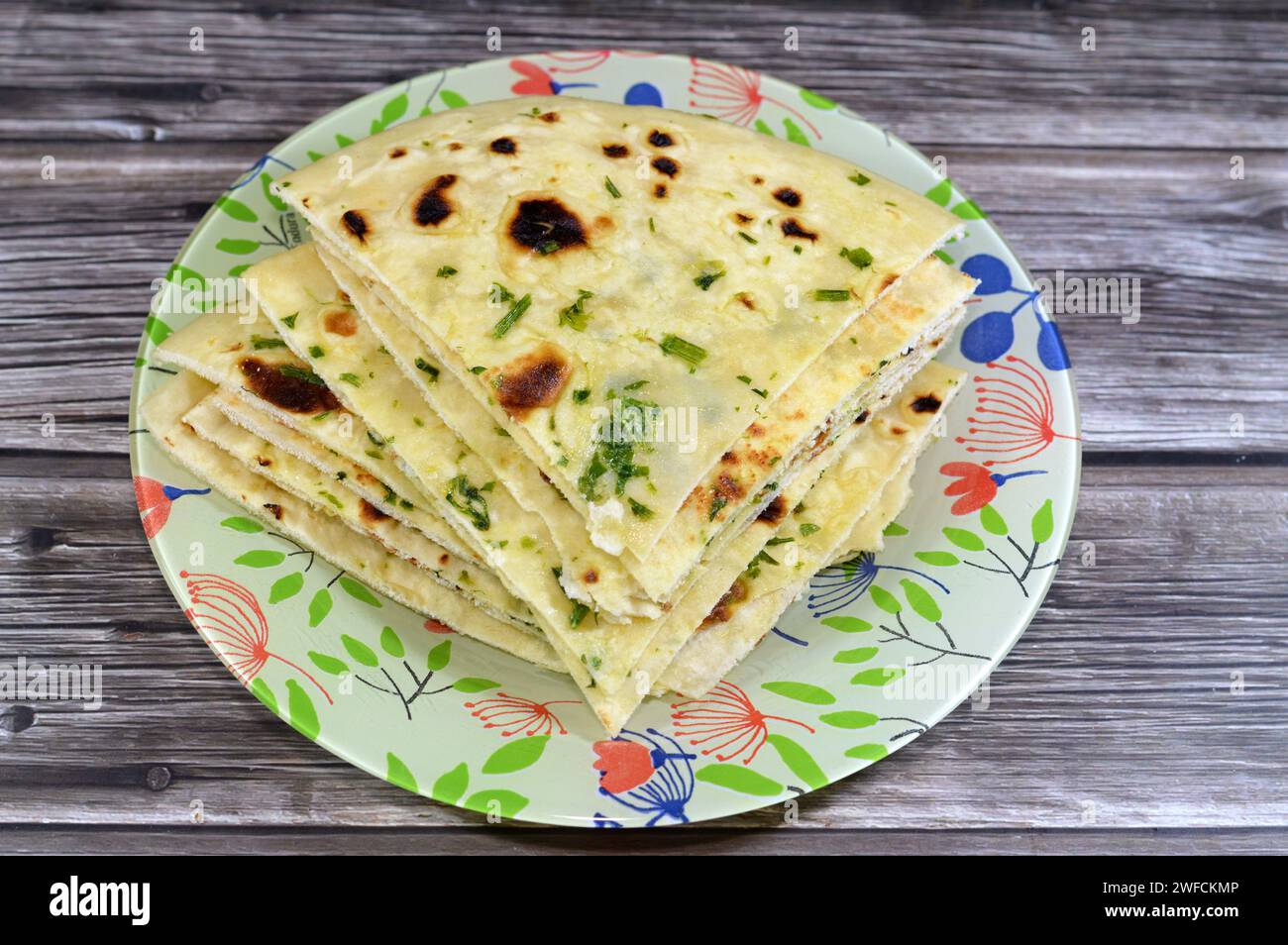 Indian naan bread baked inside a very hot clay tandoor oven, delicious ...
