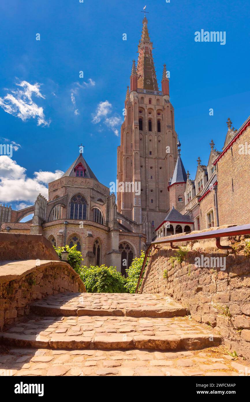 Scenic cityscape with a medieval fairytale Church of Our Lady in Bruges ...