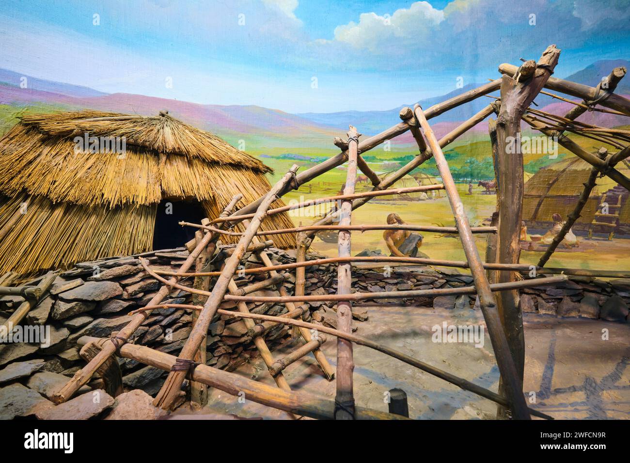View of a diorama featuring wood log, stick framework for a rural ...