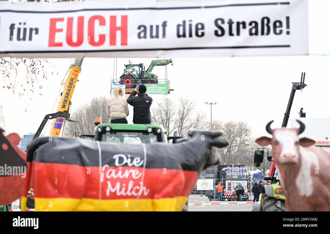 30 January 2024, Baden-Württemberg, Stuttgart: With a tractor hanging ...
