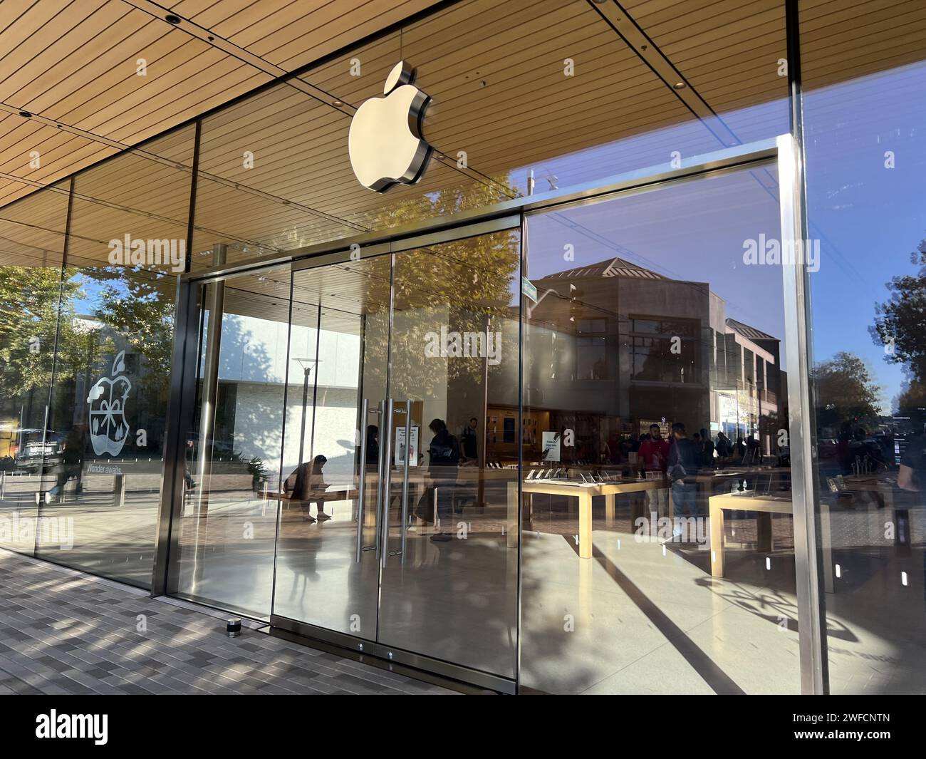 Exterior view of an Apple Store with large glass facade and logo ...