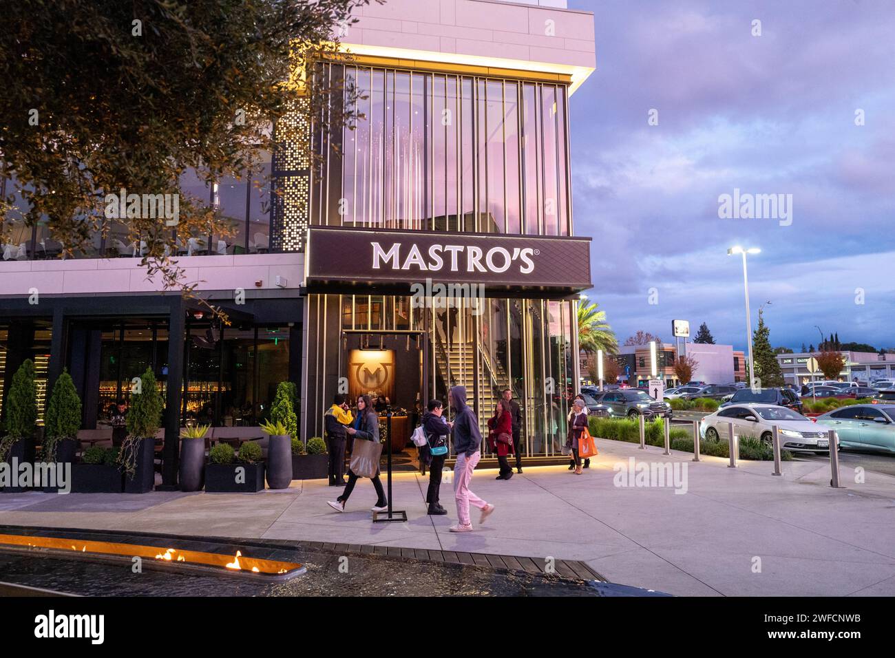 Exterior view of Mastro's Steakhouse at twilight with outdoor fire ...