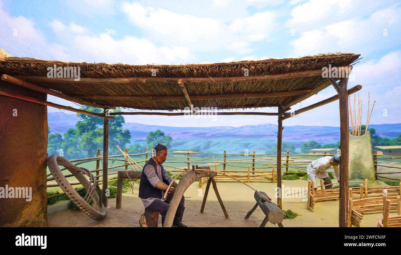 View of a diorama featuring a worker bending steamed sticks, logs, for ...