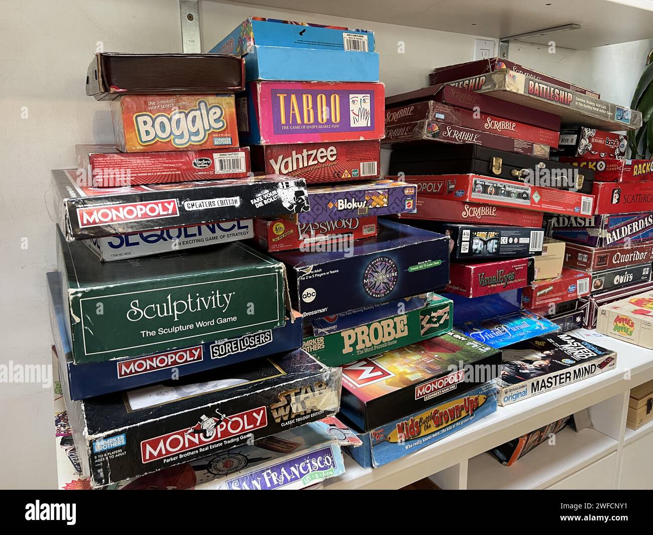 Pile of various classic board games including Monopoly, Scrabble, and ...
