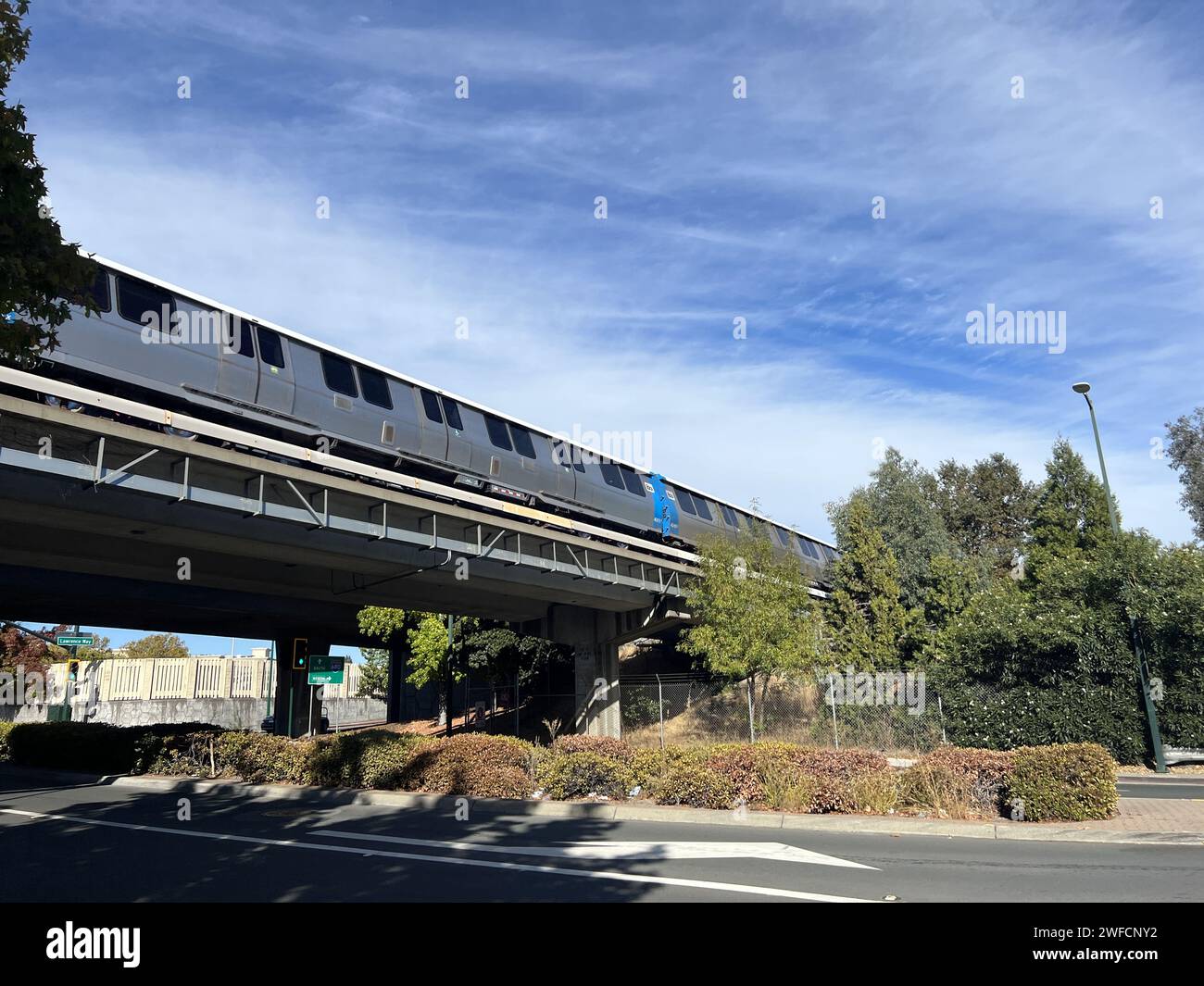 BART train passing over Parkside Drive on an elevated track on a clear ...