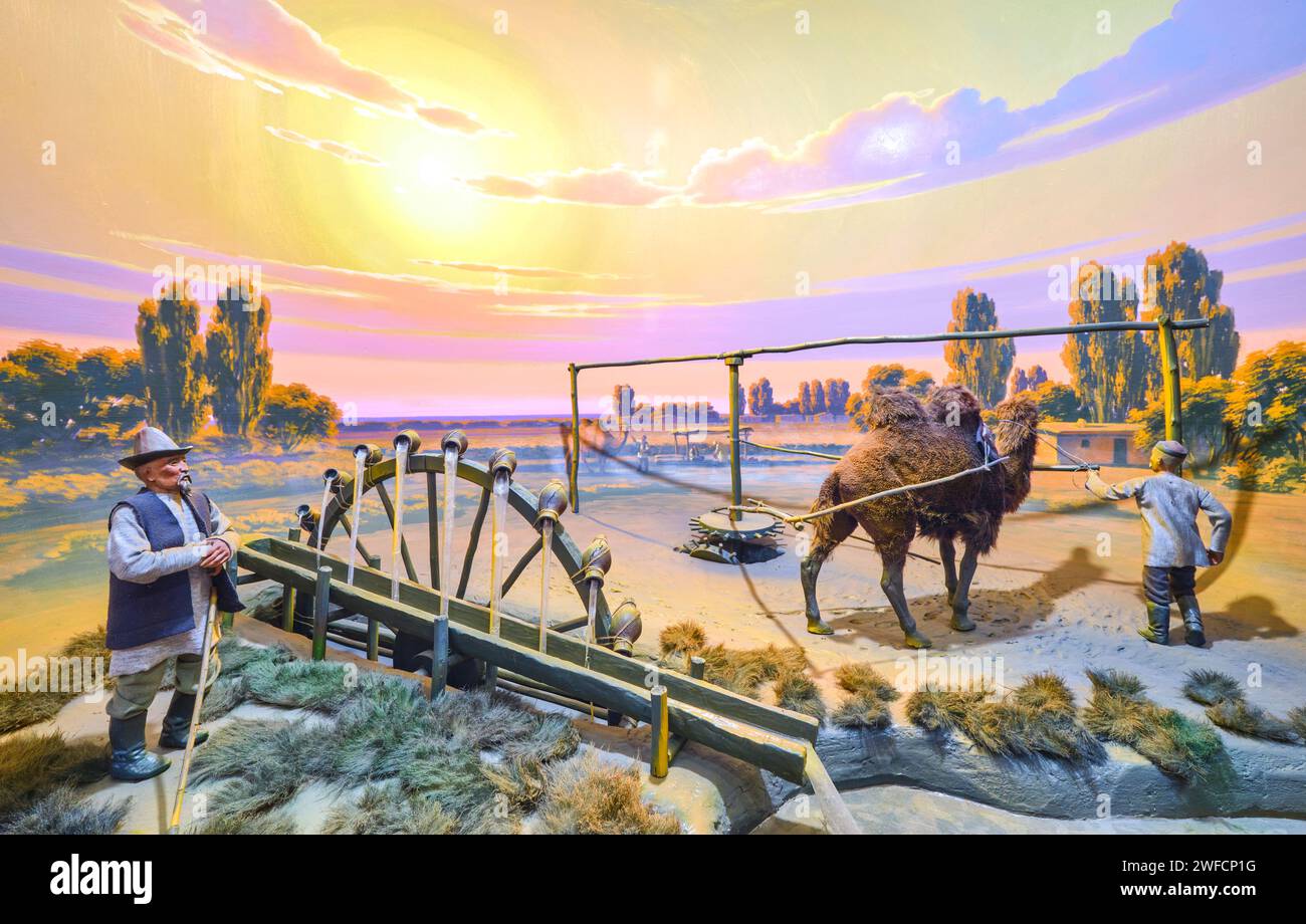 View of a diorama featuring a camel being used as a power source of a ...