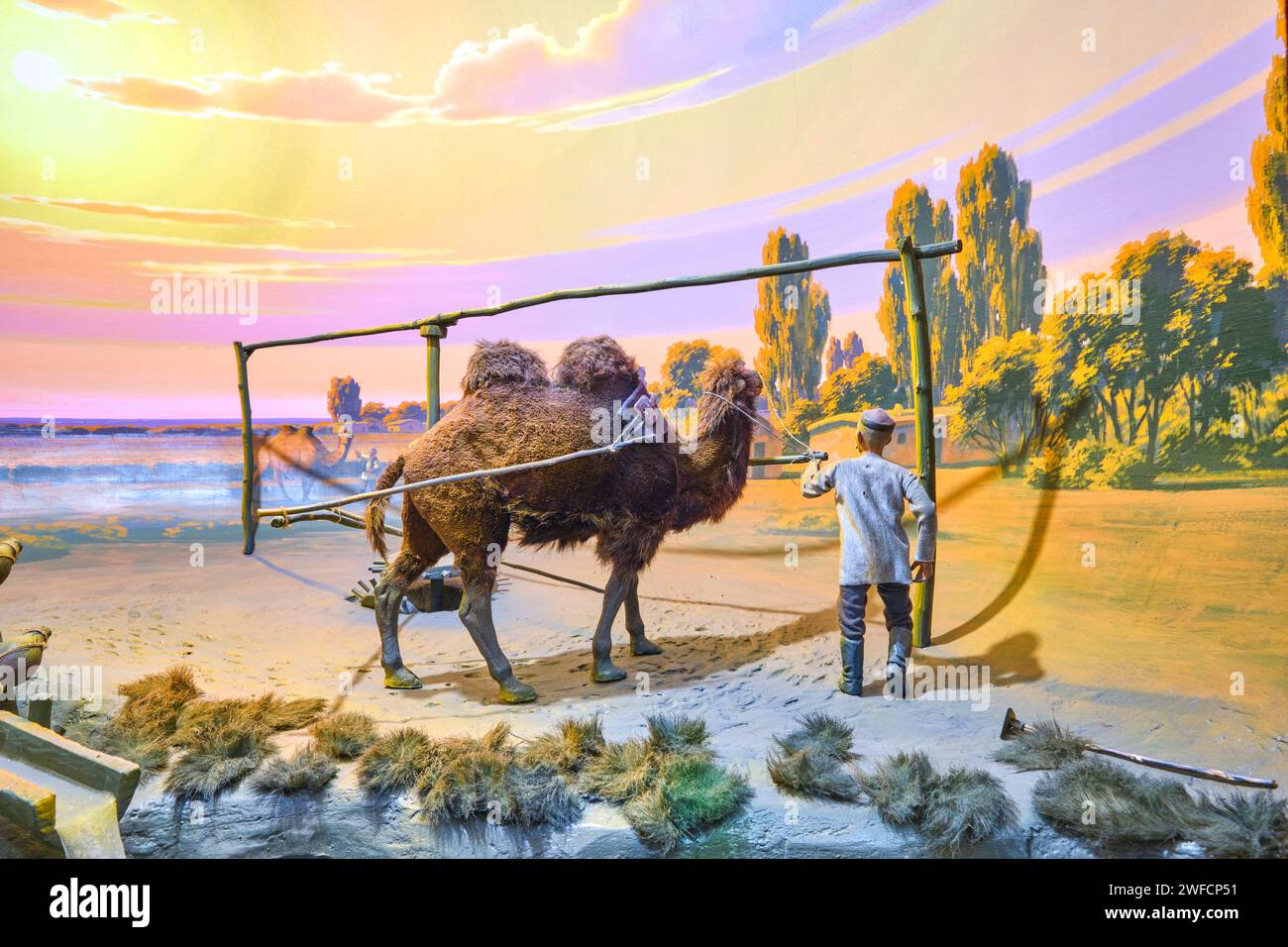 View of a diorama featuring a camel being used as a power source of a ...