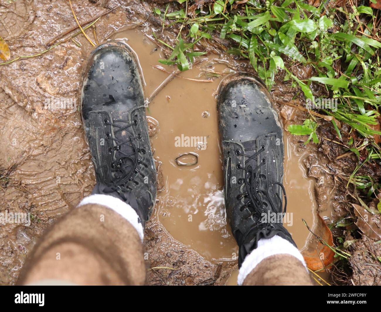 Combat boots in deep soggy mud Stock Photo - Alamy