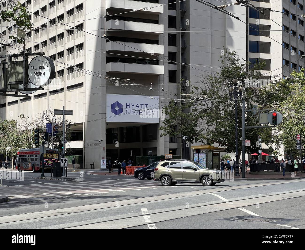 Exterior of Hyatt Regency hotel with signage, bustling street scene ...