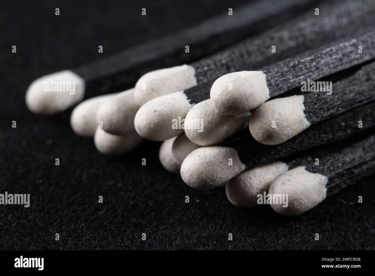 Black wooden matches on black background. Matchsticks with bright blue ...