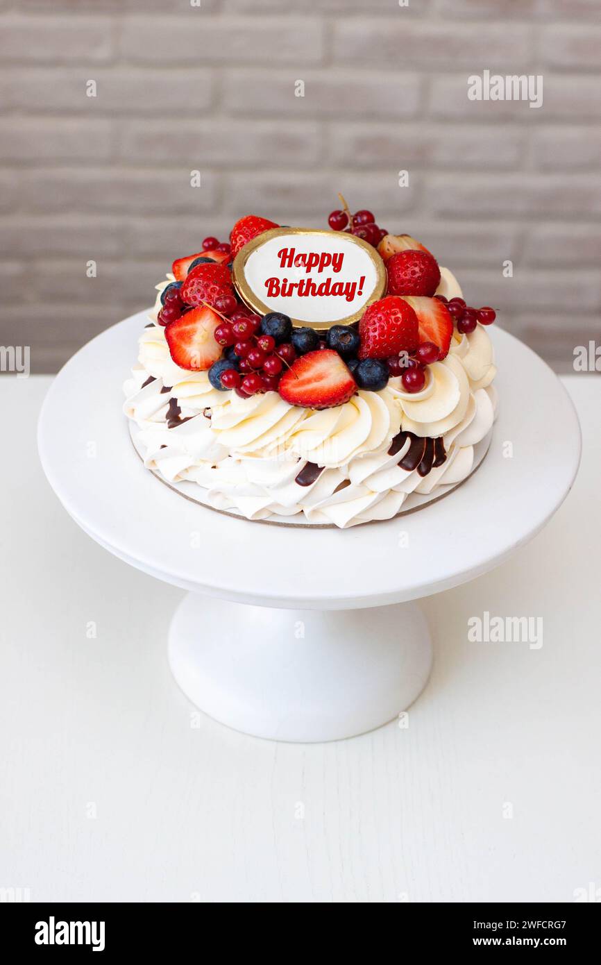 Pavlova cake with whipped cream cheese, chocolate sauce and fresh ...